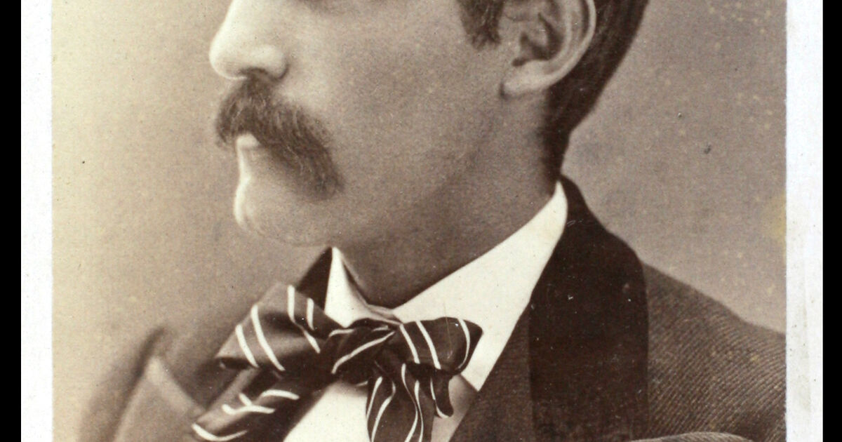 SALT Research: [A studio portrait of a young man with a mustache]